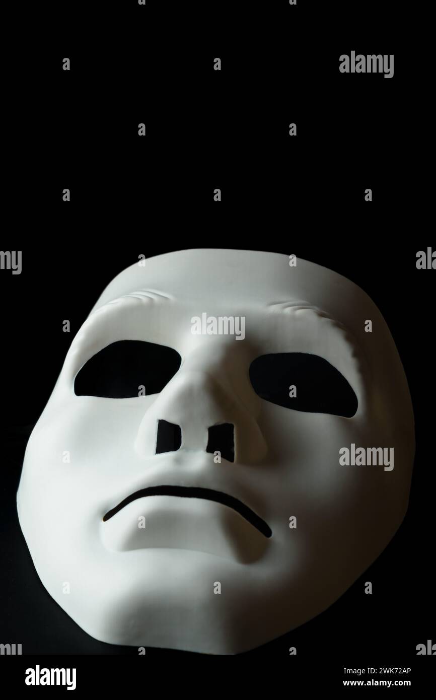 White mask isolated on black background Stock Photo - Alamy