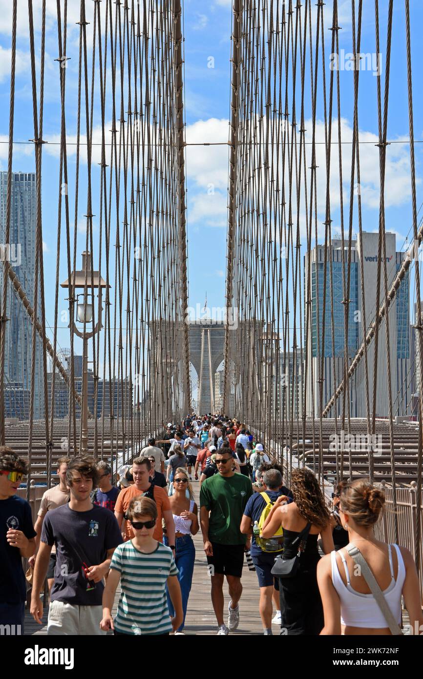 Crowd of people on Brooklyn Bridge, rope suspension, Manhattan ...