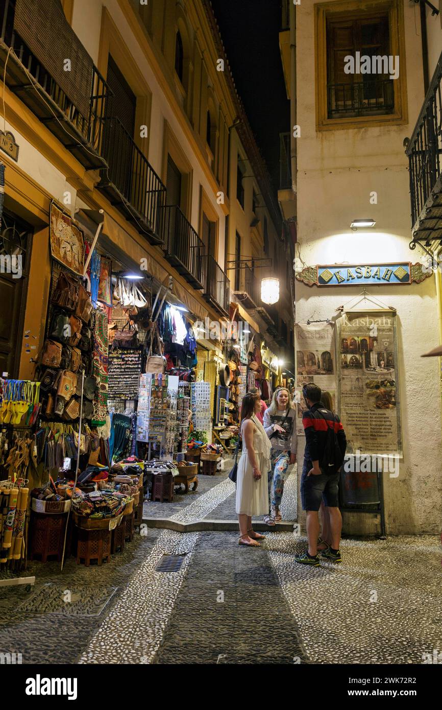 Pedestrians, tourists in the illuminated old town, night shot, Granada ...