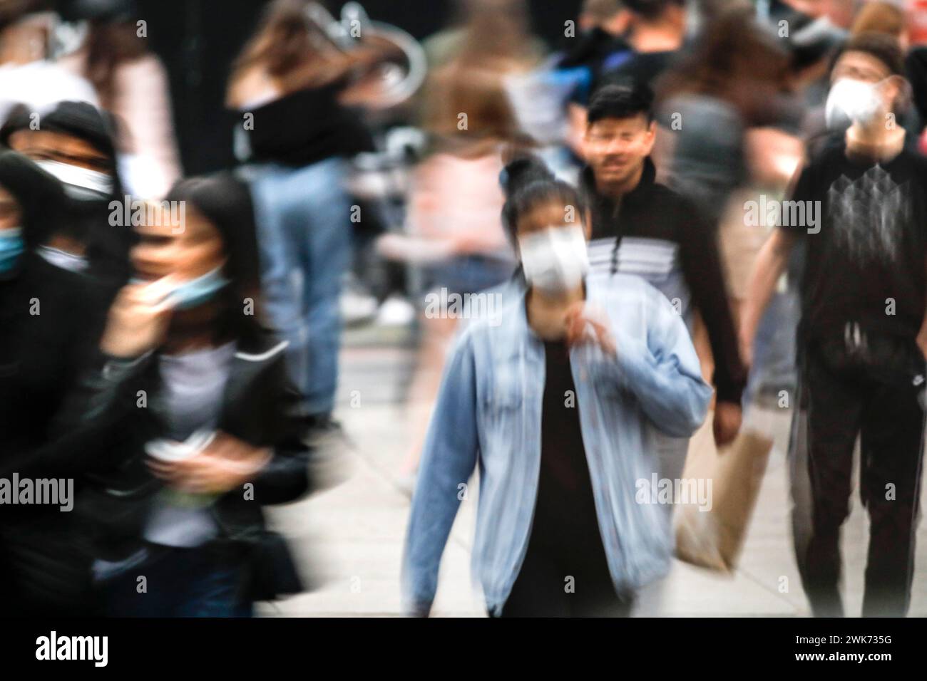 Dense crowds around Alexanderplatz. People with masks. Difficult to ...
