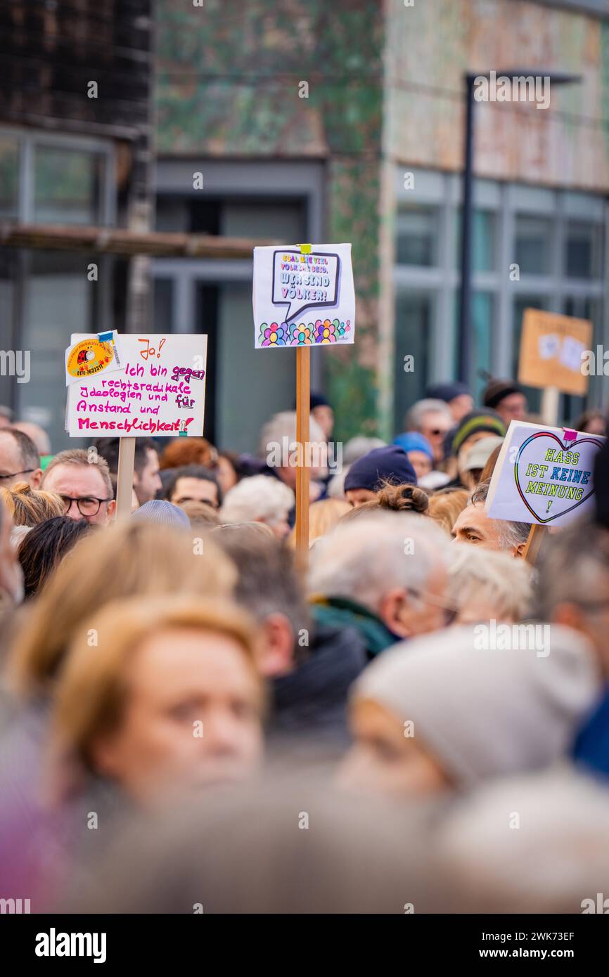 People holding up various signs with political and social messages ...