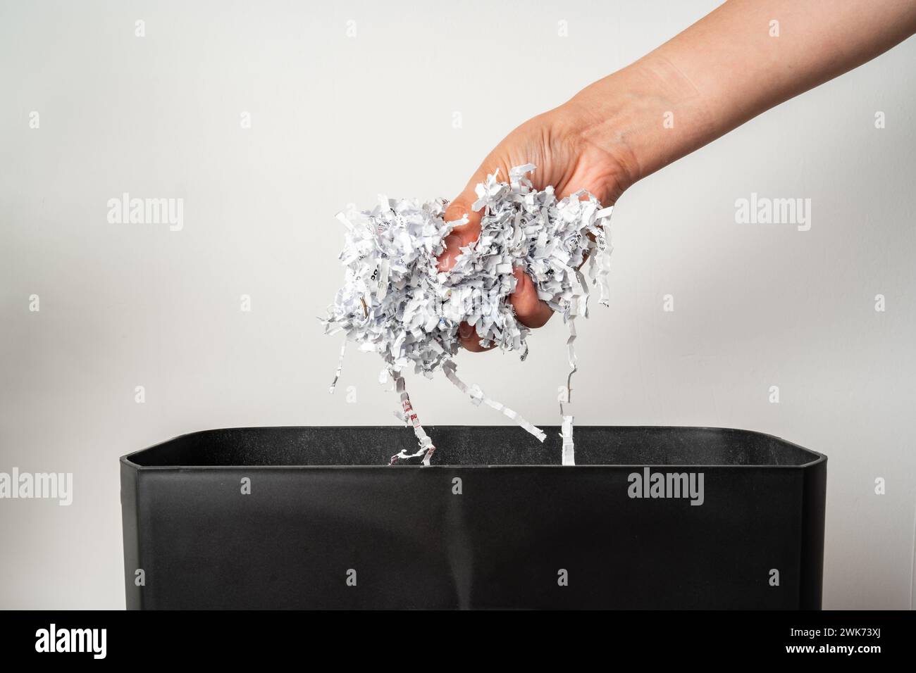 Male hand holding a bunch of shredded paper Stock Photo - Alamy