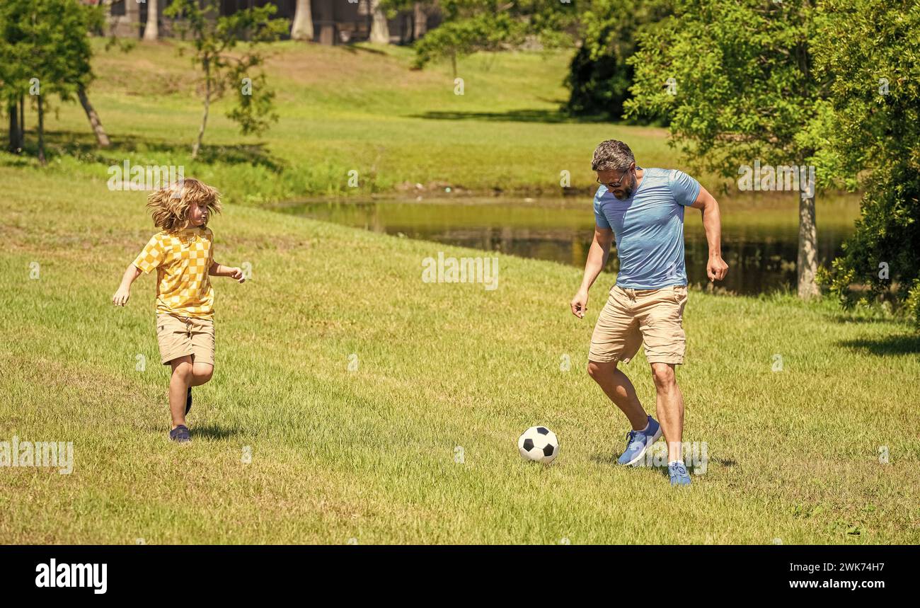 Active father son playing football in summer. Father and child son ...