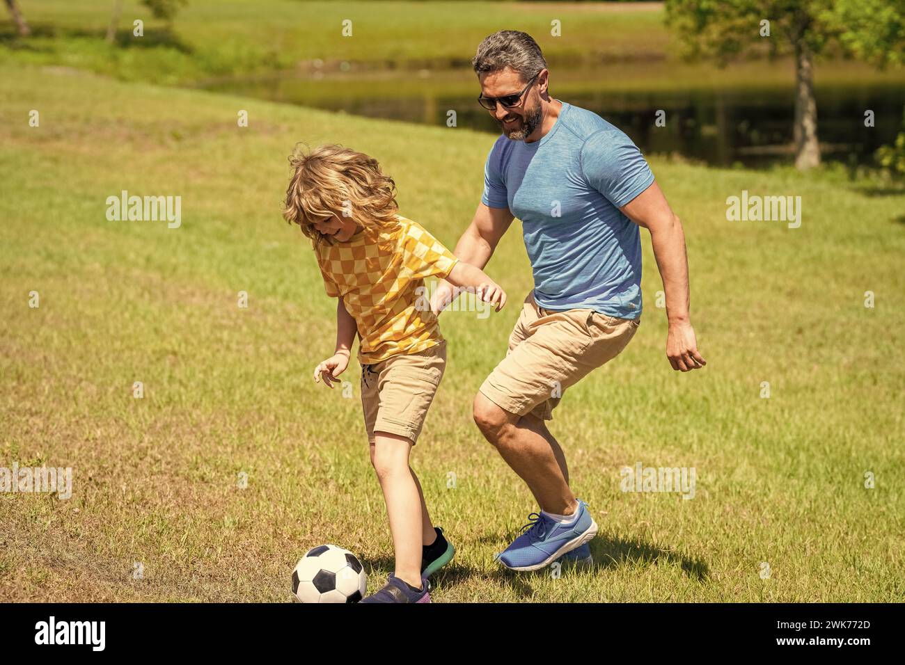 football family team of father and son. soccer activity. Fatherhood in ...