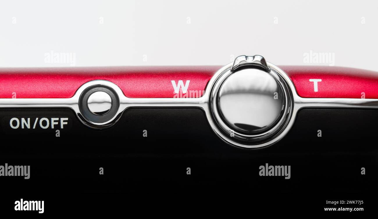 Close-up of the on/off button and focal length adjustment lever of a ...