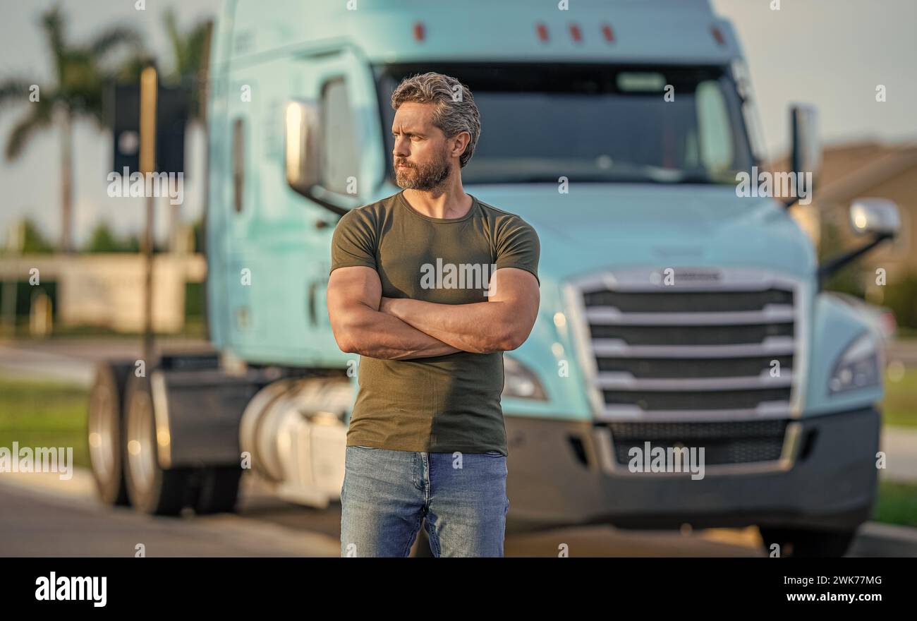 Trucking owner. hispanic man posing in front of truck. Semi trucks ...