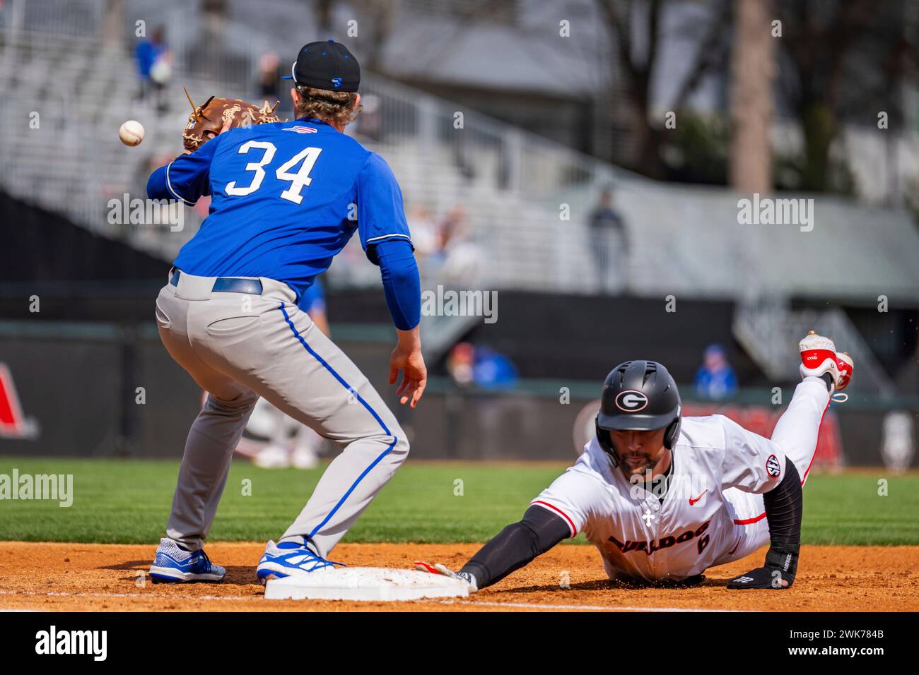 Georgia catcher Corey Collins (6) slides into 1st before getting tagged ...