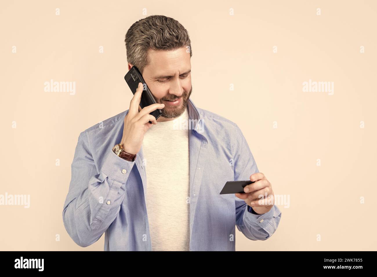 happy man contact by call card isolated on studio background. man ...