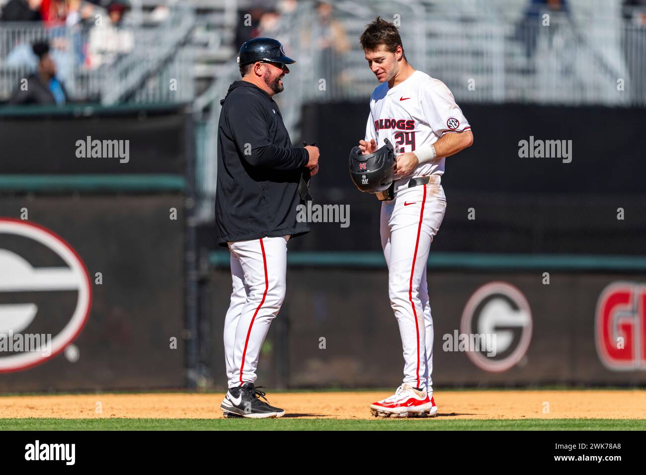 Georgia outfielder Charlie Condon (24) gives his equipment to the 3rd ...