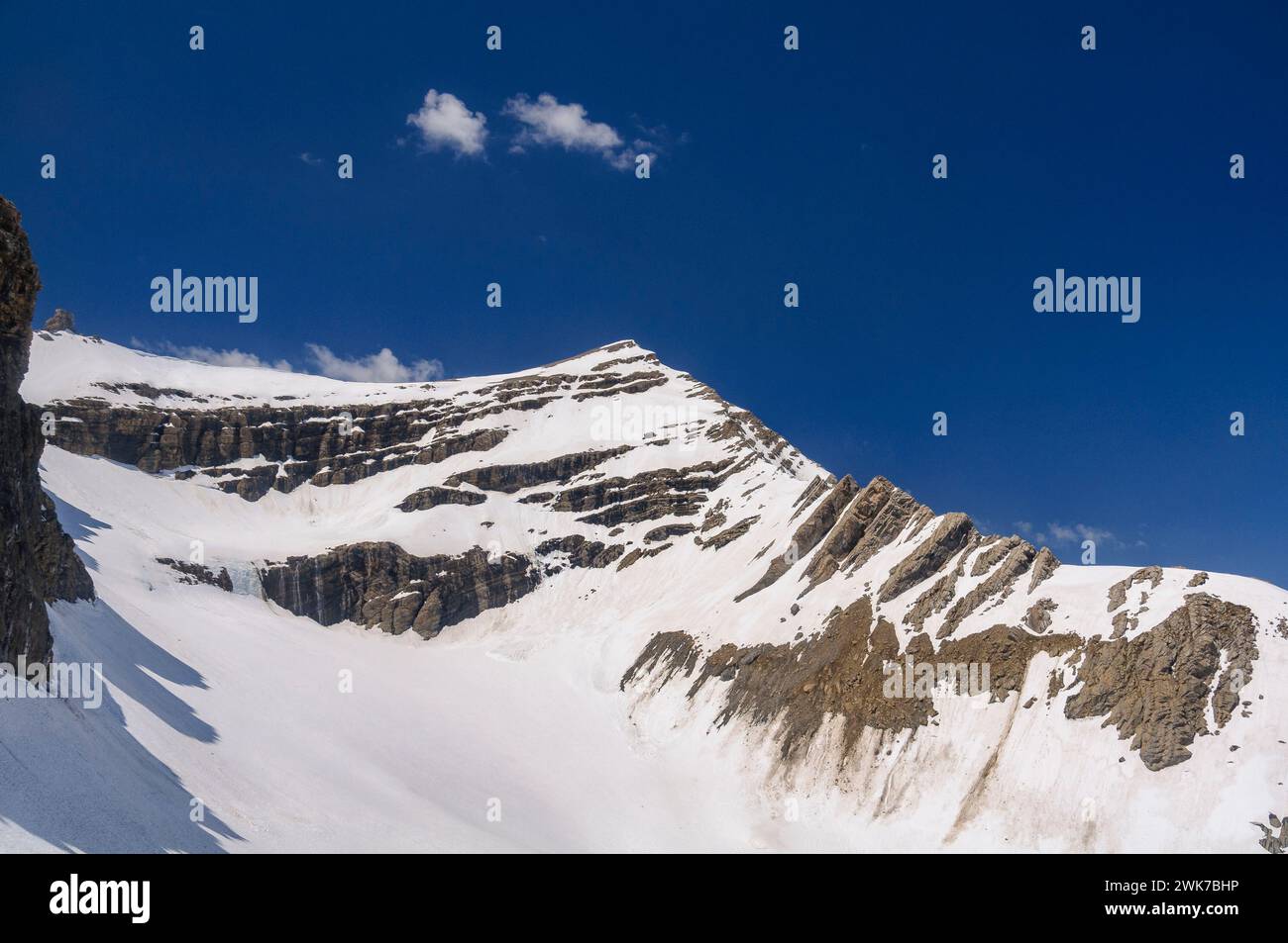Snow-capped Taillon peak and glacier, with remains of some avalanches ...