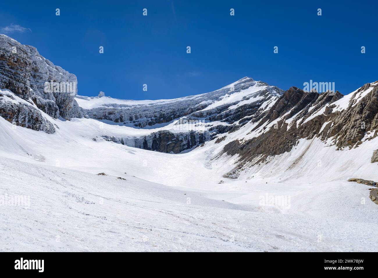 Snow-capped Taillon peak and glacier, with remains of some avalanches ...