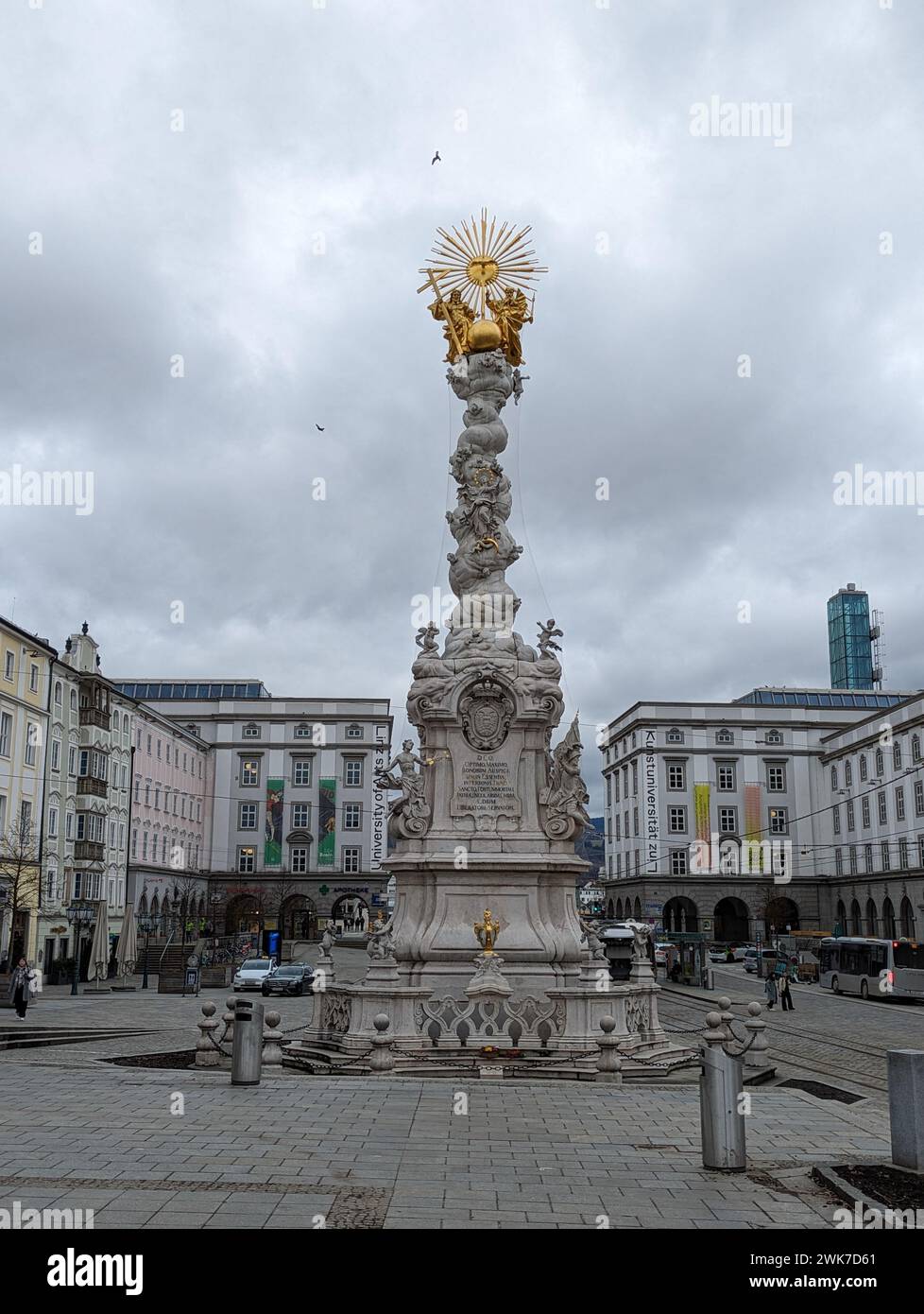 The Statue of Jesus atop a column in open area with buildings in ...