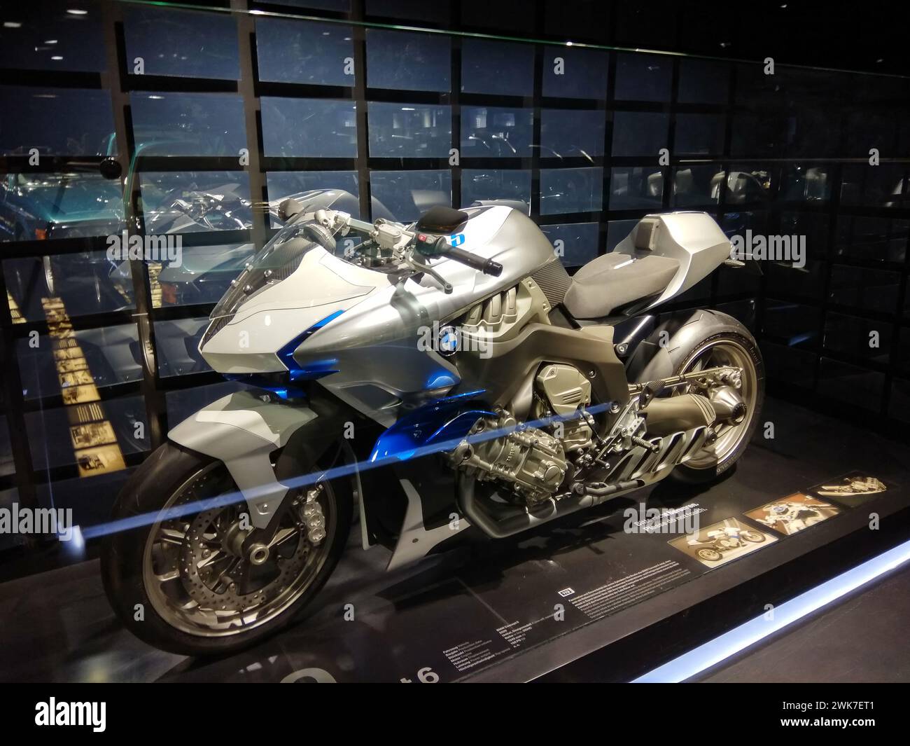 A sleek silver motorcycle showcased in a glass display case Stock Photo ...