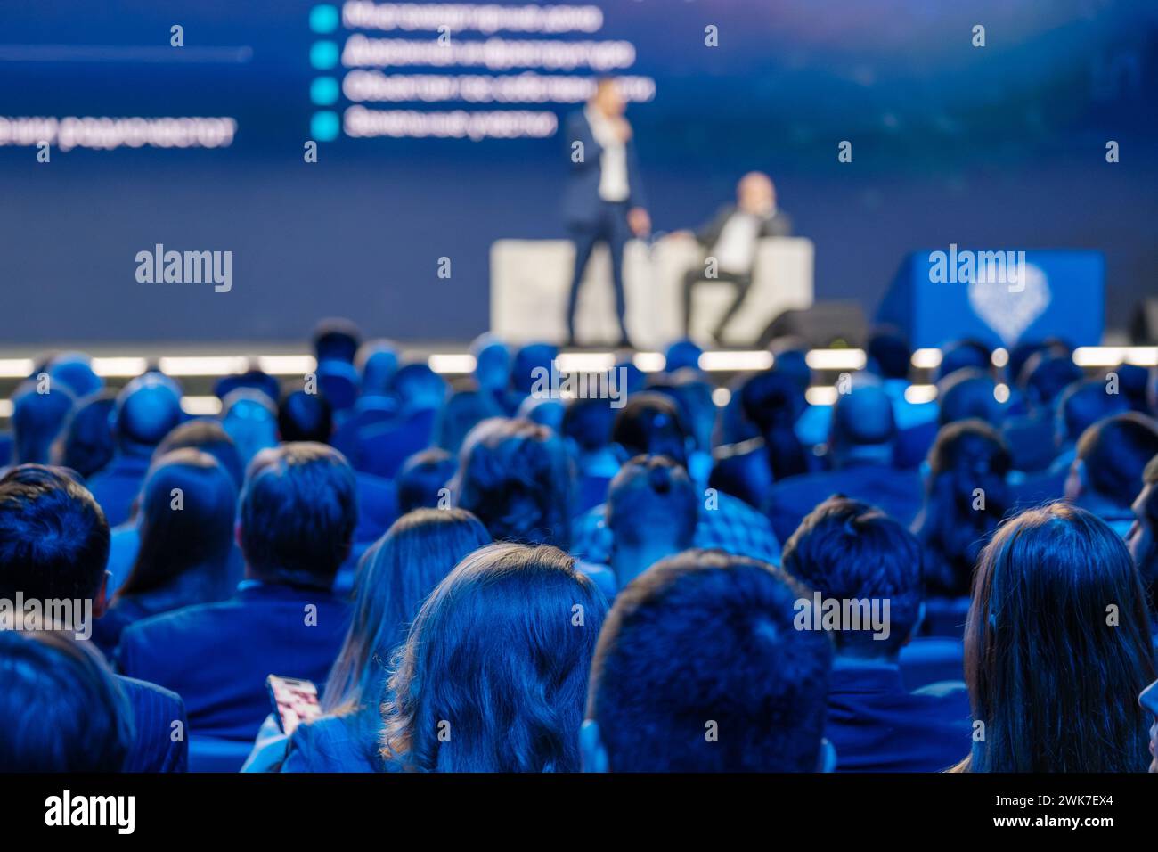 Speakers on stage addressing an attentive audience at a professional ...