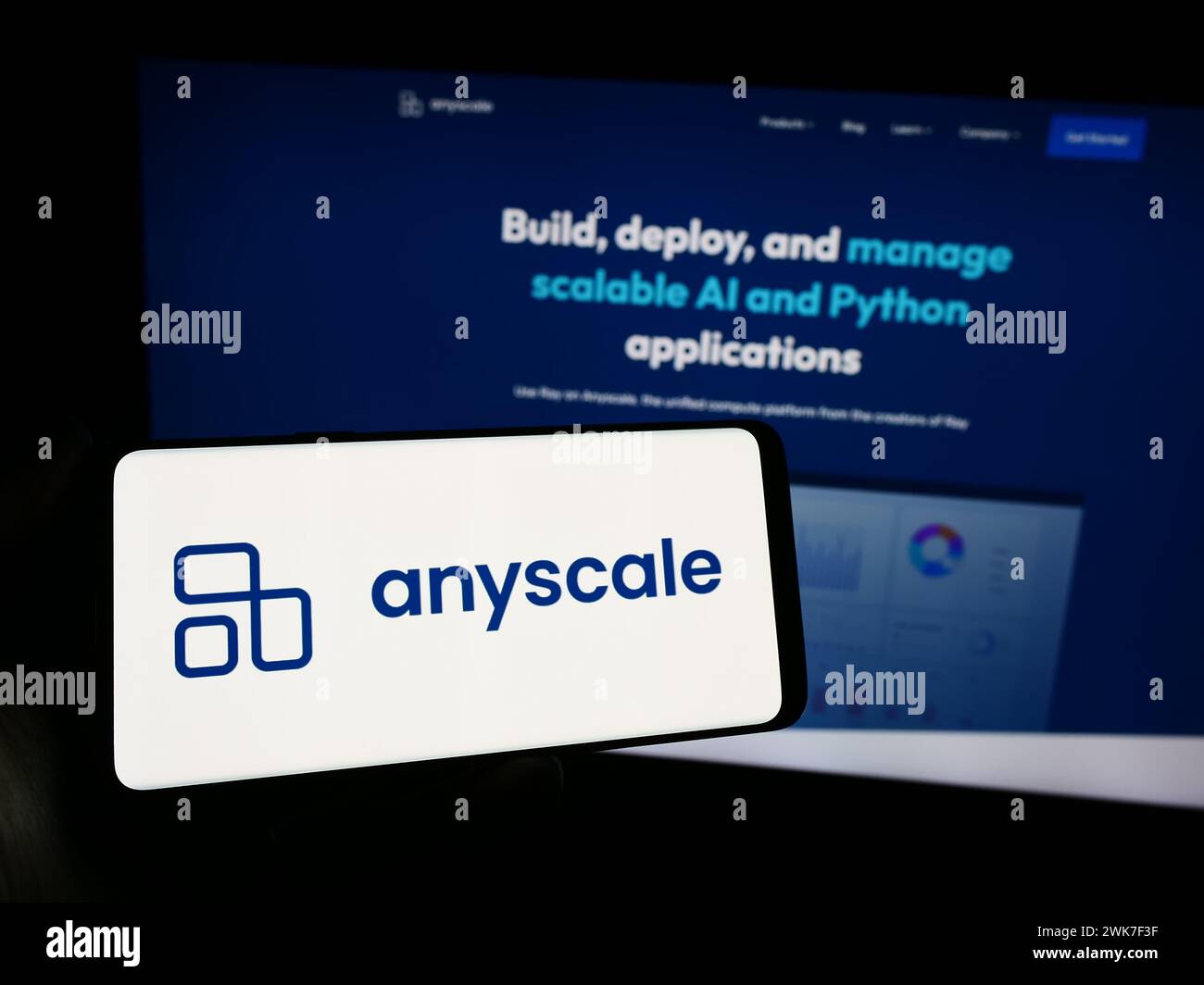 Person holding mobile phone with logo of American AI infrastructure ...