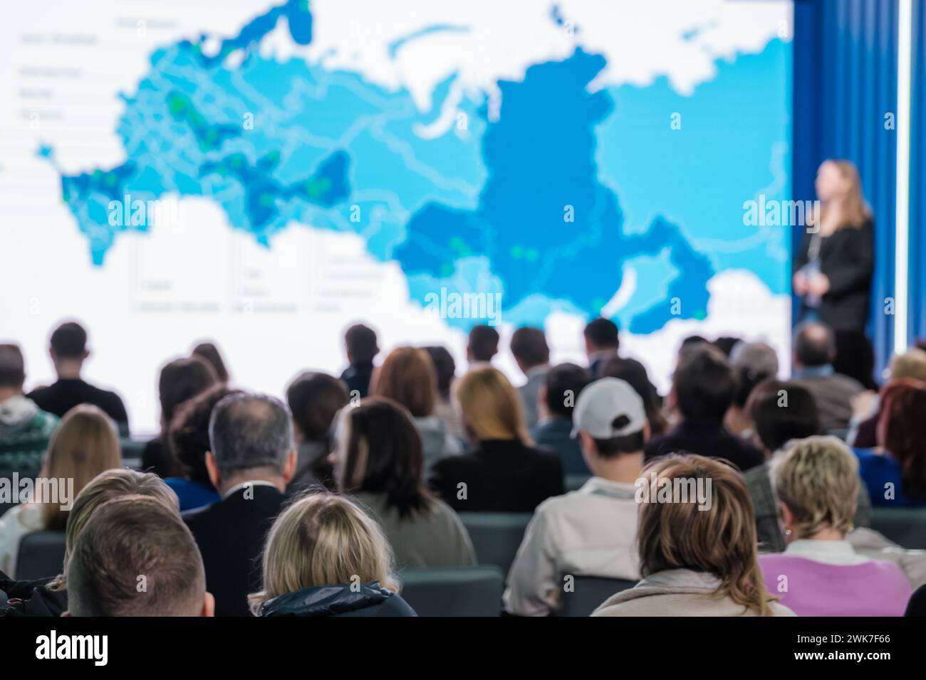 Focused shot of a business presentation to a diverse audience with a ...