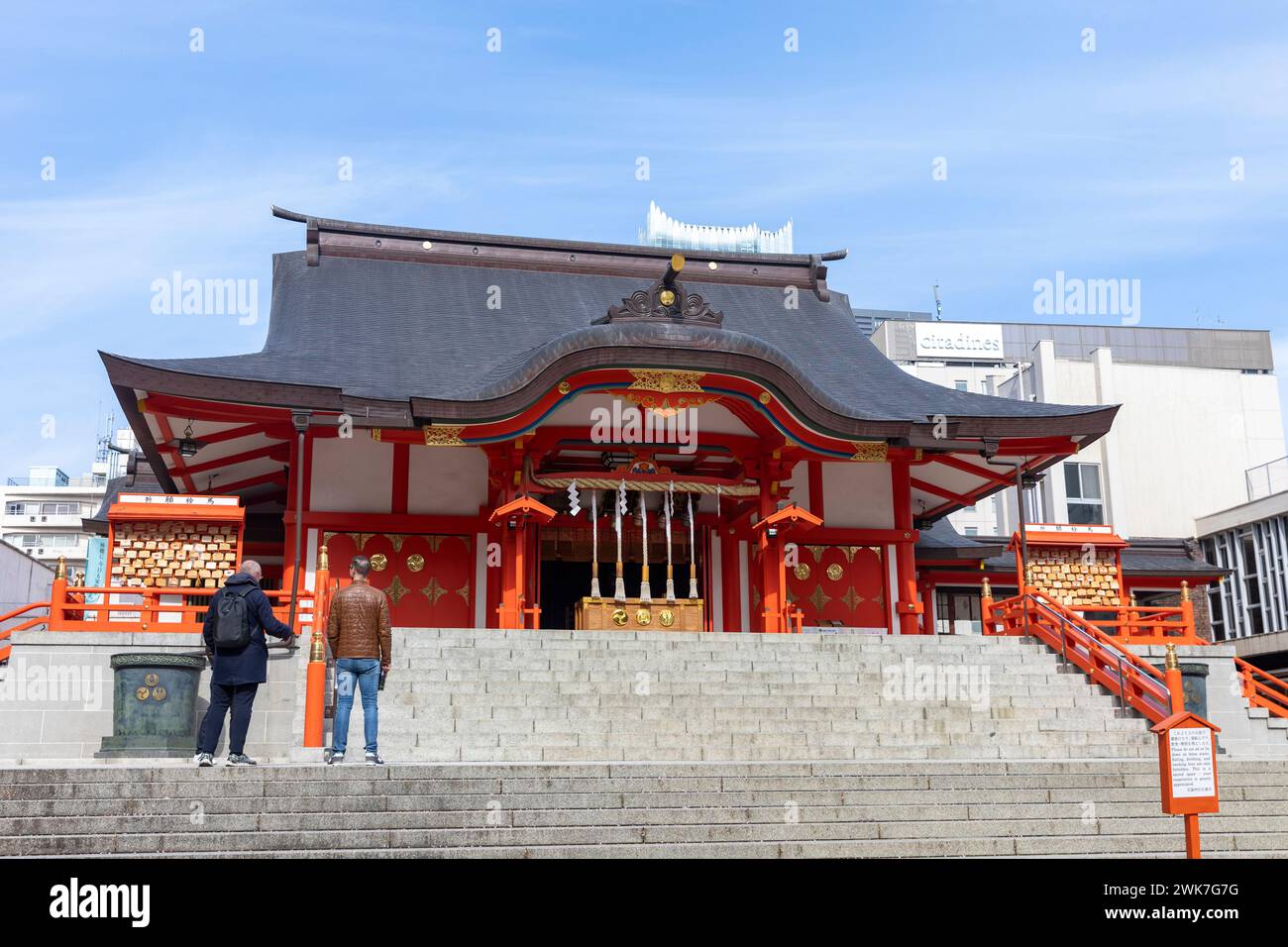 Shinjuku ward Tokyo, Hanazono shinto shrine,twov people standing on the ...
