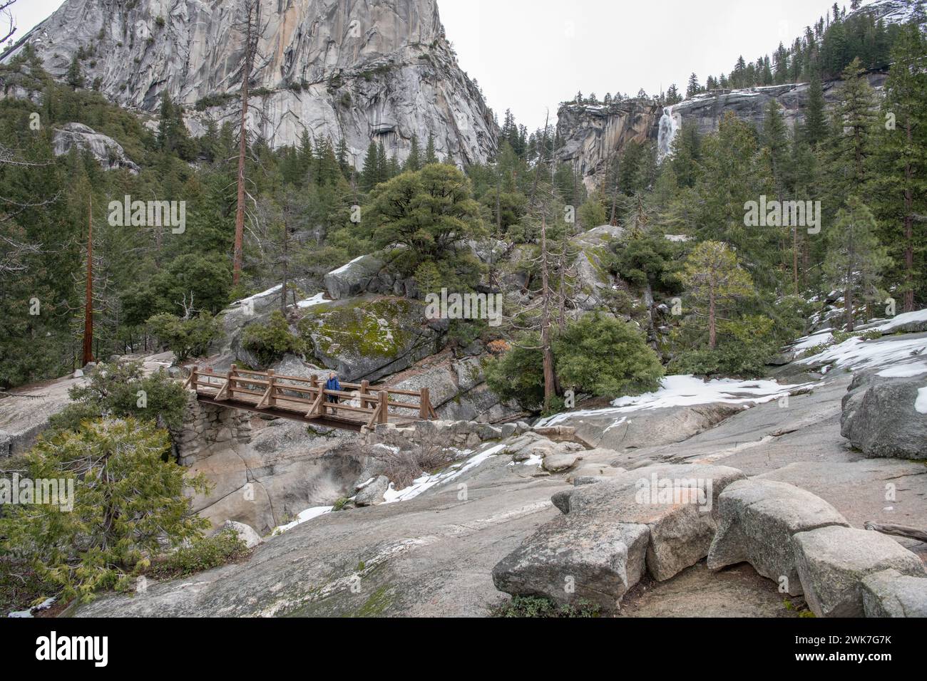A wooden bridge over a rocky chasm in the Sierra Nevada mountains of ...
