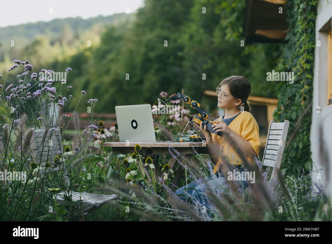 Girl working on robotic arm. Concept robotics, science, IT technologies ...