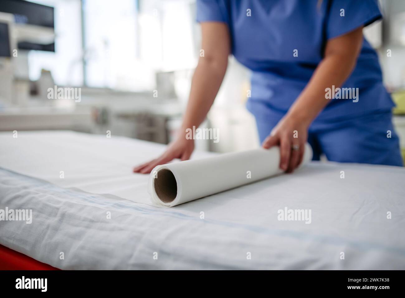 Nurse preparing the examination table in emergency room, examination ...