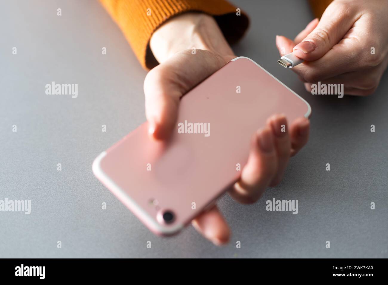 Woman plugging smartphone power hi-res stock photography and images - Alamy