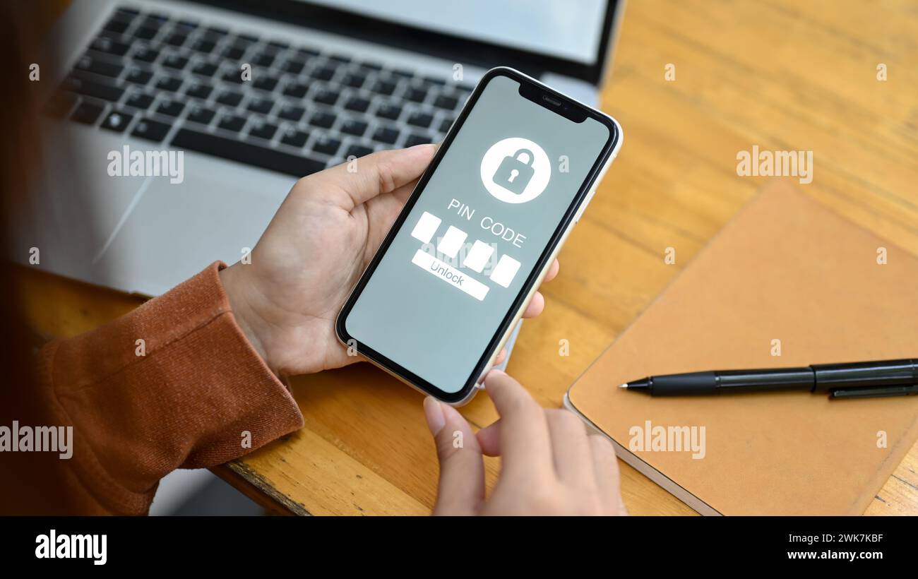 Woman hands entering the PIN code on the smartphone. Data security ...