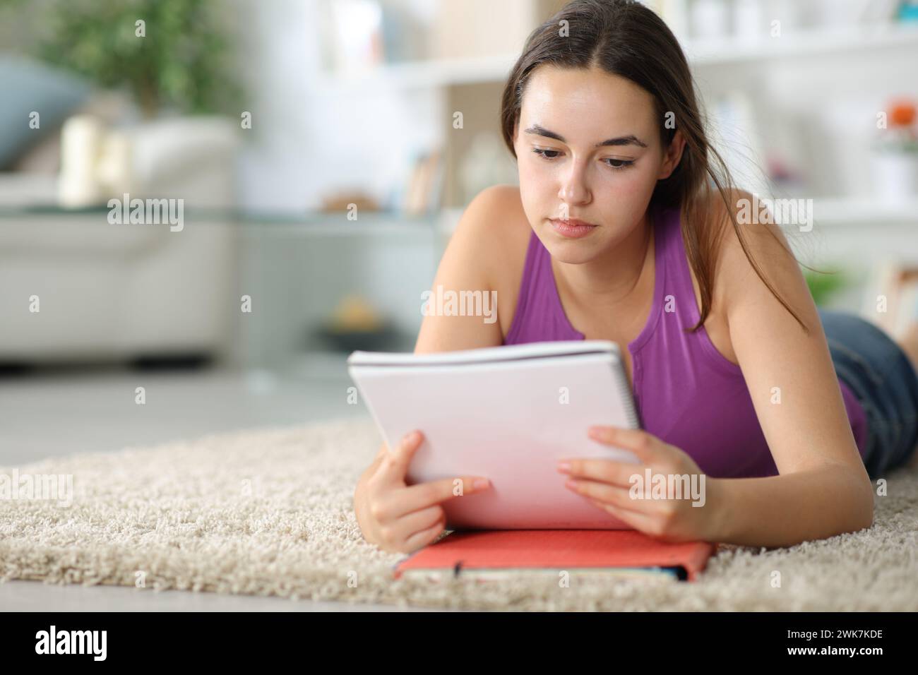 Student learning reading notes lying on the floor at home Stock Photo ...