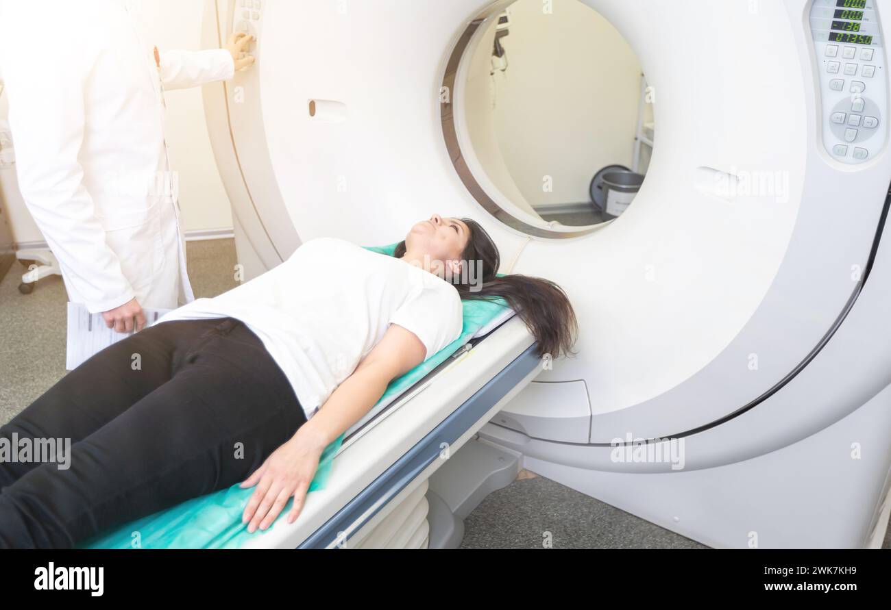 beautiful woman lying on ct scanner bed during tomography test in ...