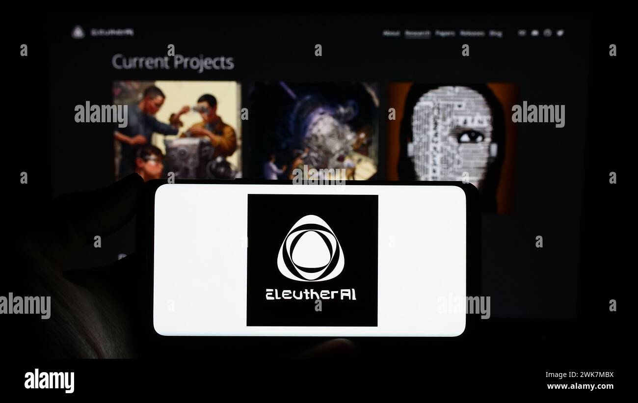 Person holding smartphone with logo of artificial intelligence research ...