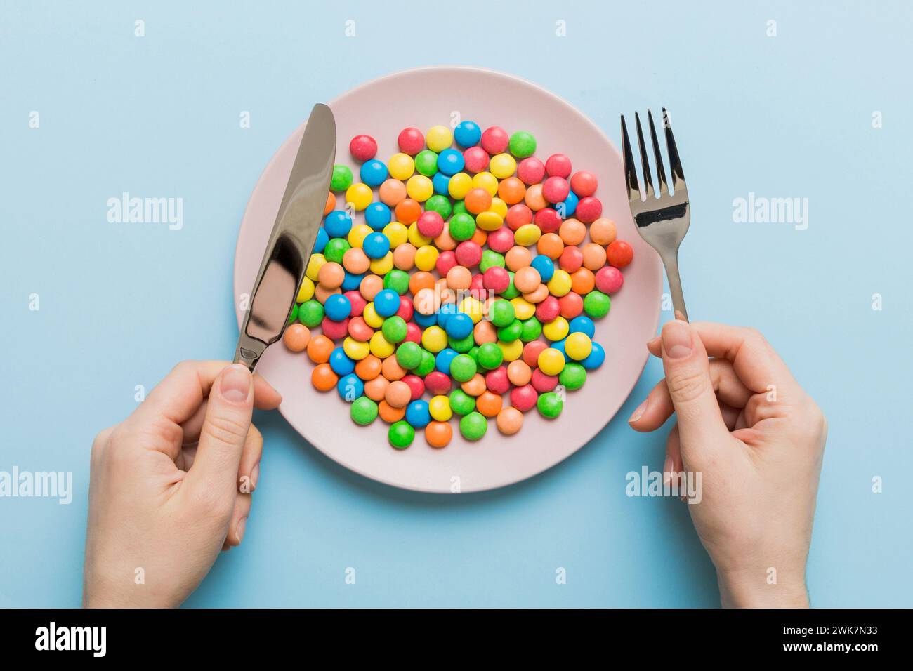 the girl holds cutlery in her hands and eats sweets in a plate. Health ...