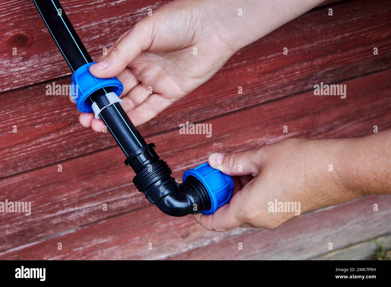 Connecting compression clamp of elbow fitting to polyethylene pipe of ...