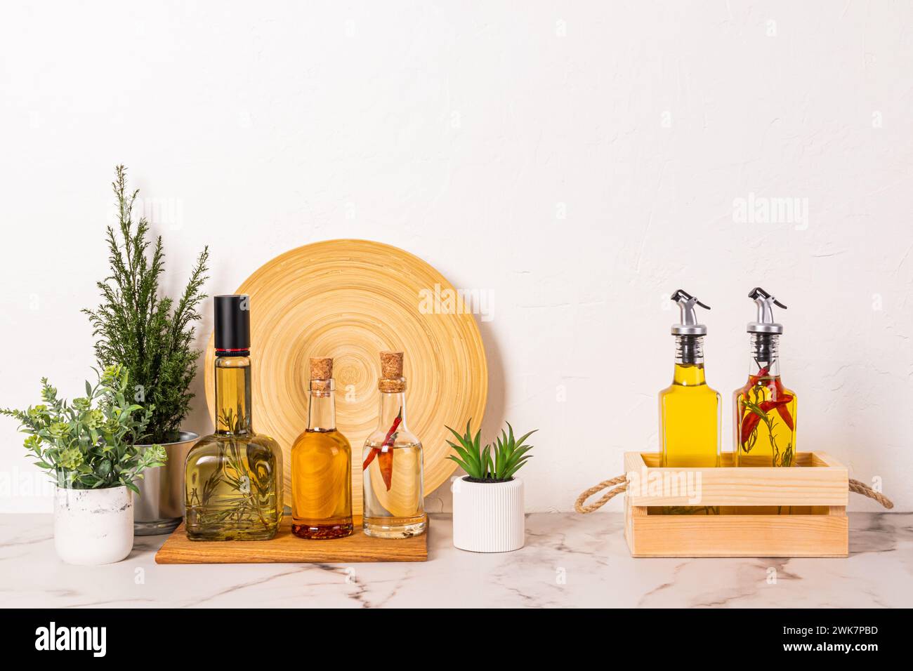 Various bottles of natural organic cooking oil in wooden box and tray ...
