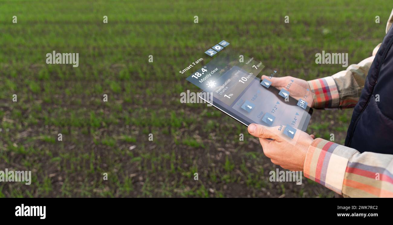 Farmer with digital tablet on an agricultural field. Close up. Smart ...
