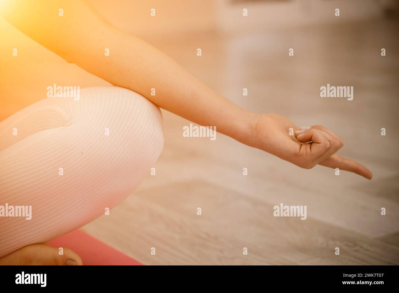 Girl does yoga. Young woman practices asanas on a beige one-ton ...