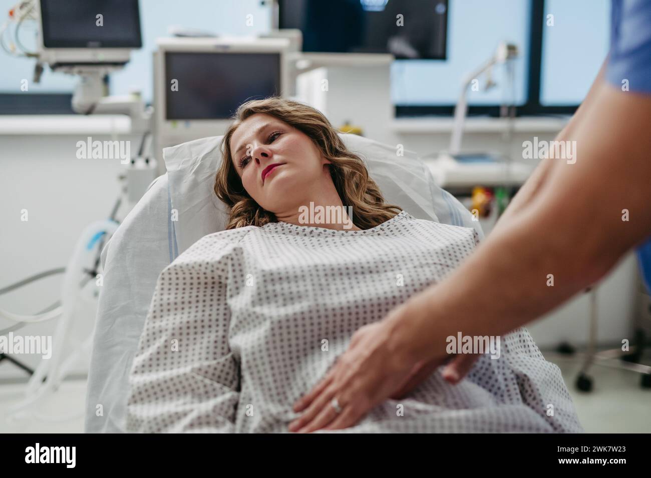 Doctor palpating woman's abdomen, using hands and steady pressure Stock ...
