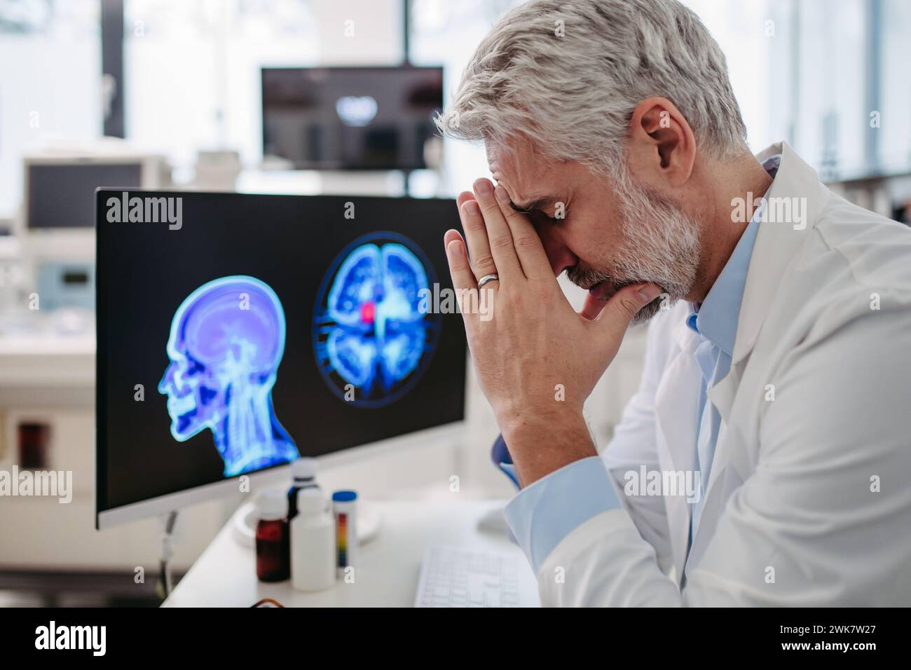 Sad doctor looks at an MRI scan, patient's bad test results, feeling ...