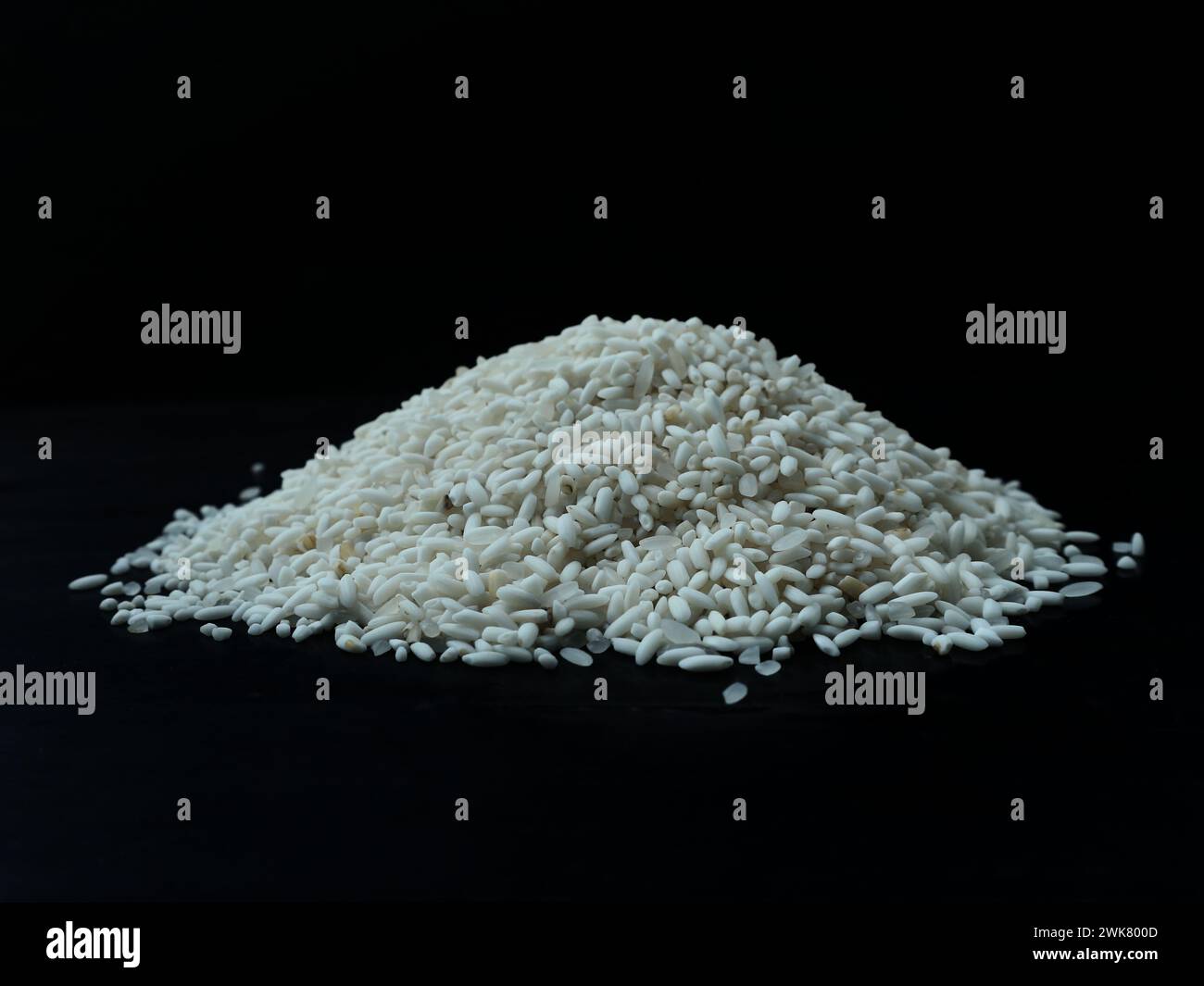 Clean white sticky rice stacked on a black background Stock Photo - Alamy