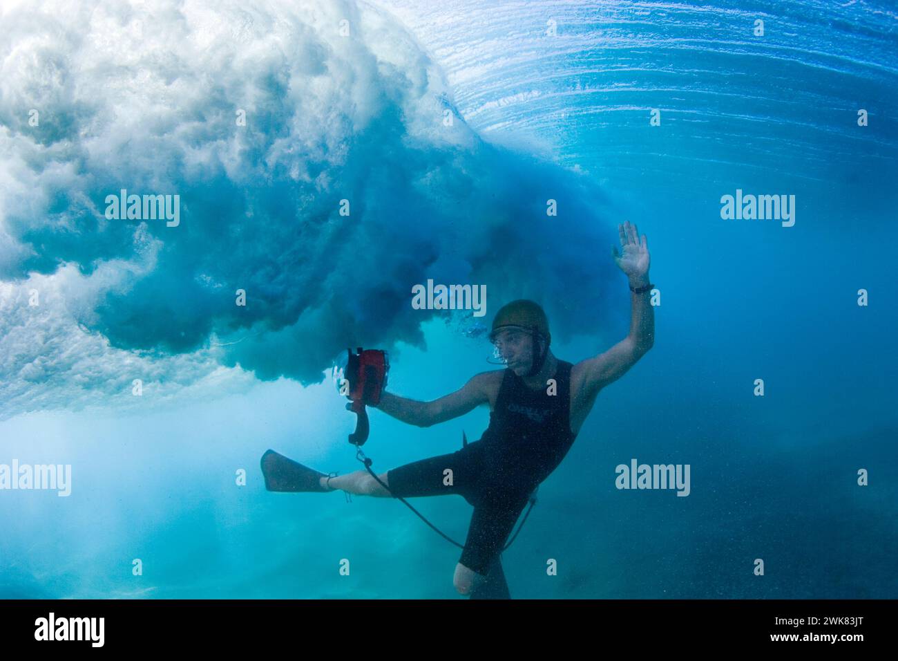 under water view of photographer underneath wave on the north shore of ...