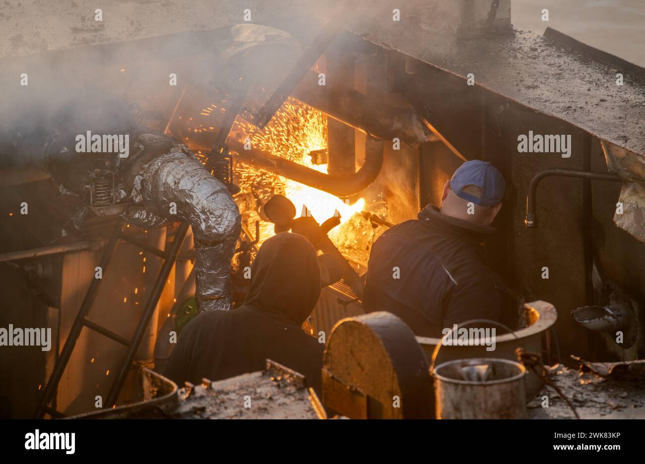 River barge scrapping process involving acetylene torch cutting by ...
