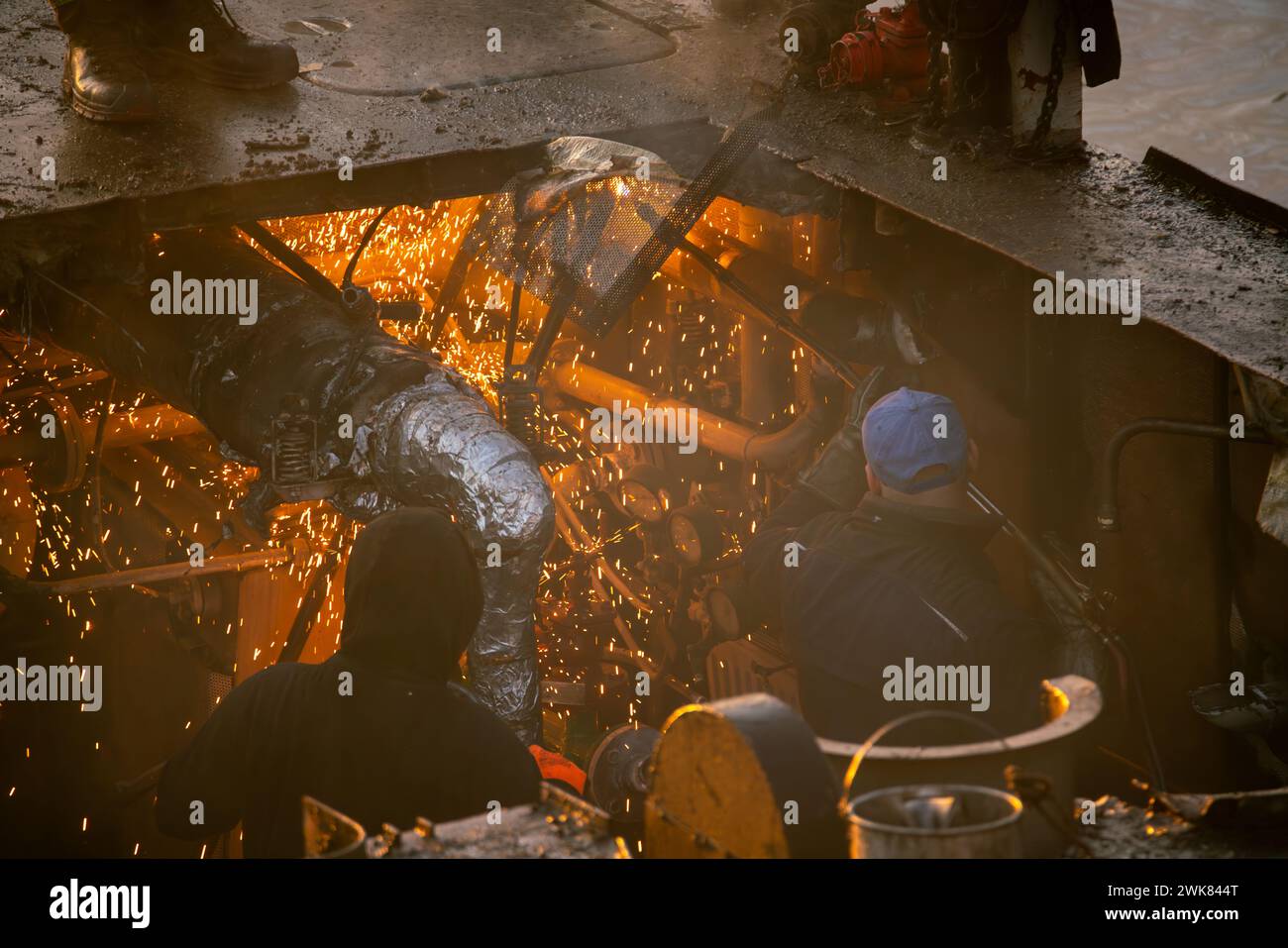 River barge scrapping process involving acetylene torch cutting by ...