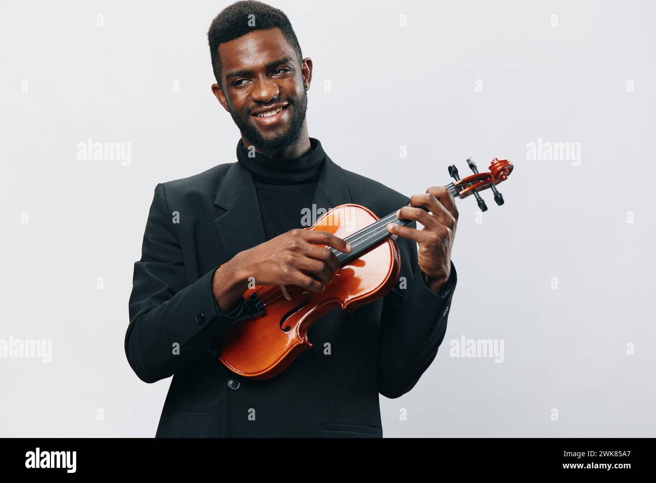 Passionate young African American man showcasing his talent by playing ...