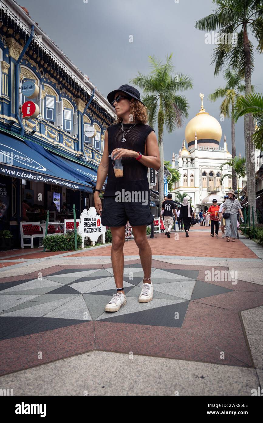 Man drinking iced tea, walking on Kamplong Glam street Stock Photo - Alamy