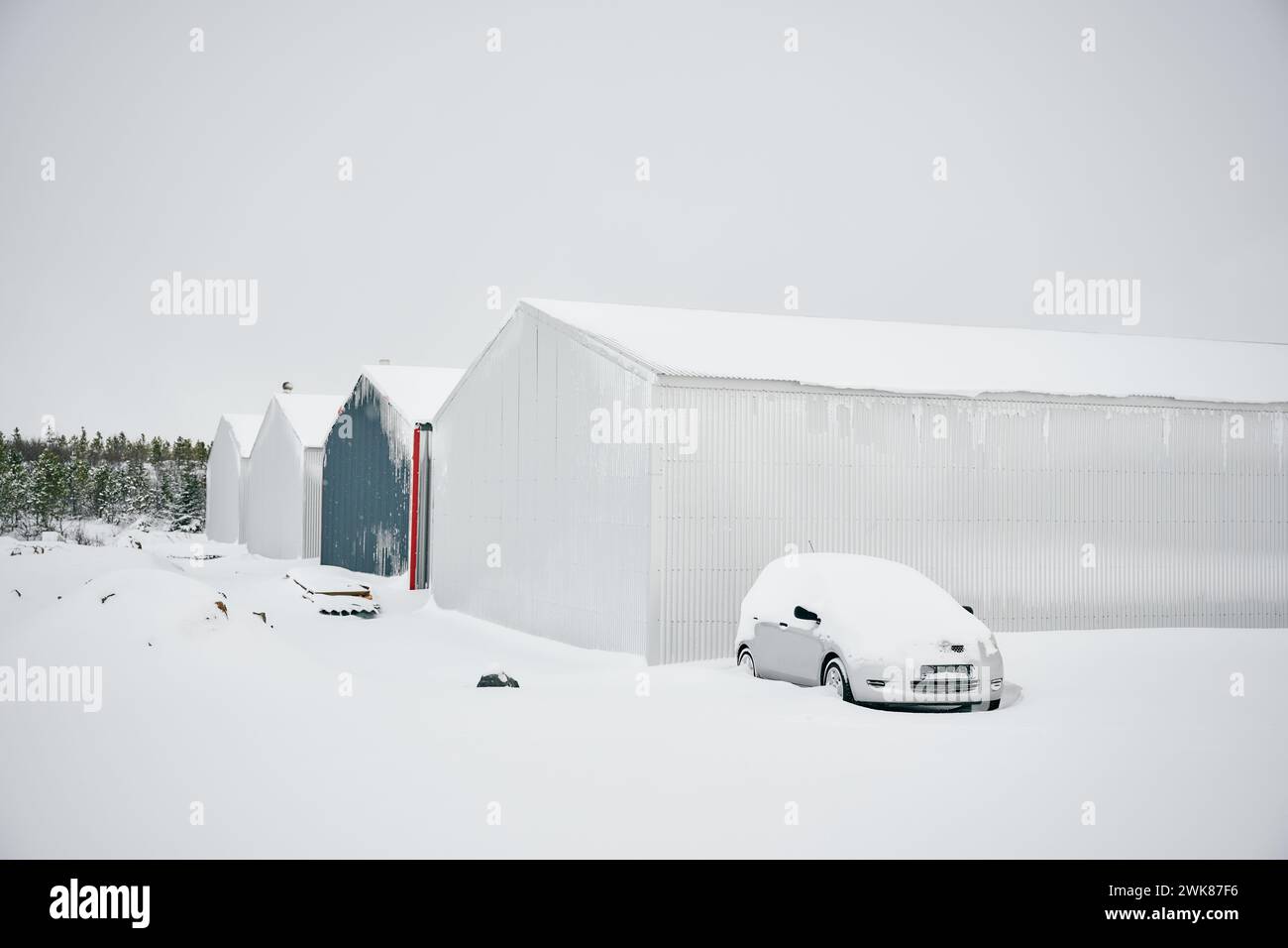 Modern storage facilities and car covered in snow during wintertime ...