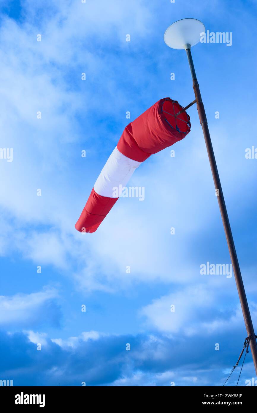 Windsock against beautiful blue sky with nice clouds Stock Photo - Alamy