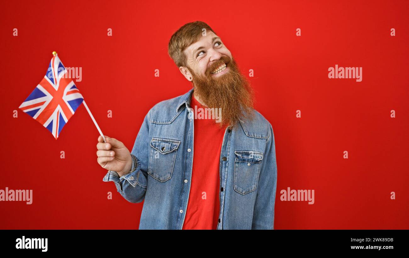 Handsome young redhead man with beard, oozing confidence, standing ...