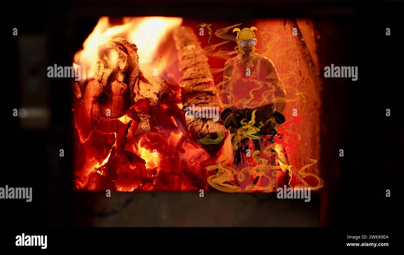 A burning fire. A creature with horns fueling the heat Stock Photo - Alamy