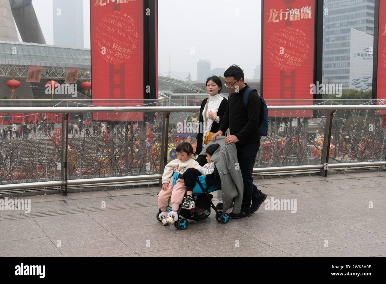SHANGHAI, CHINA - FEBRUARY 19, 2024 - A two-child family travels on the ...