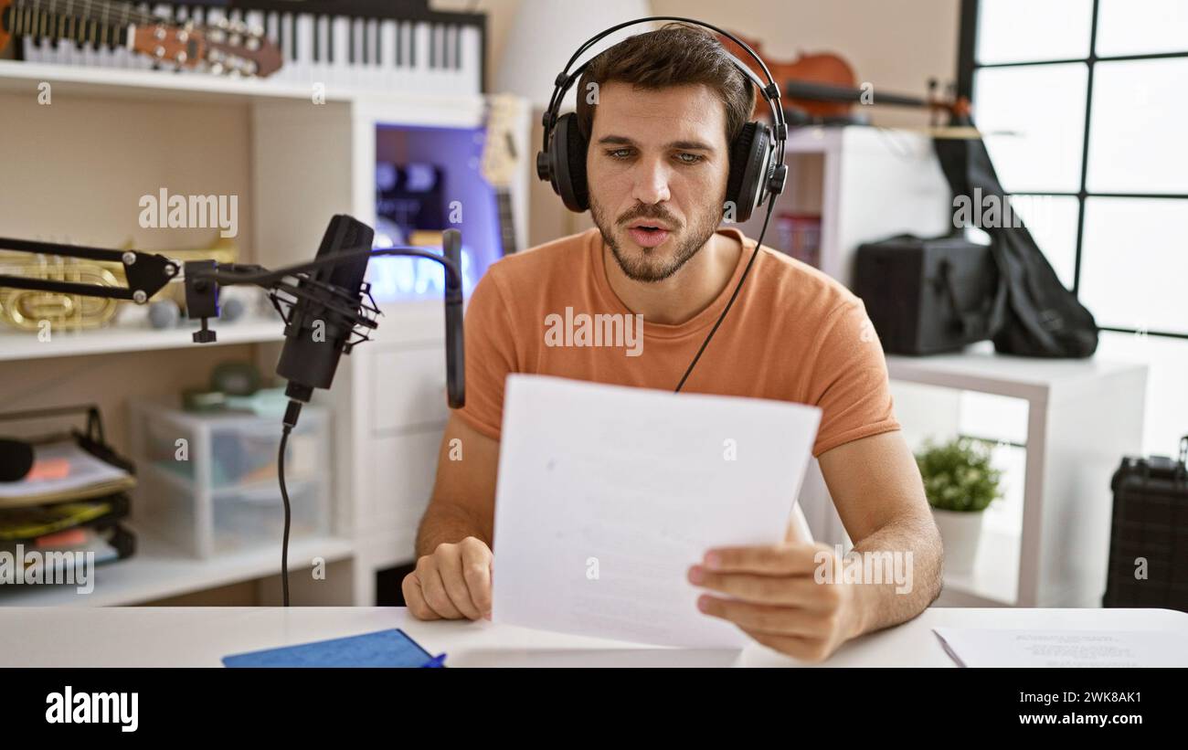 A focused young man in headphones reading a script in a modern ...