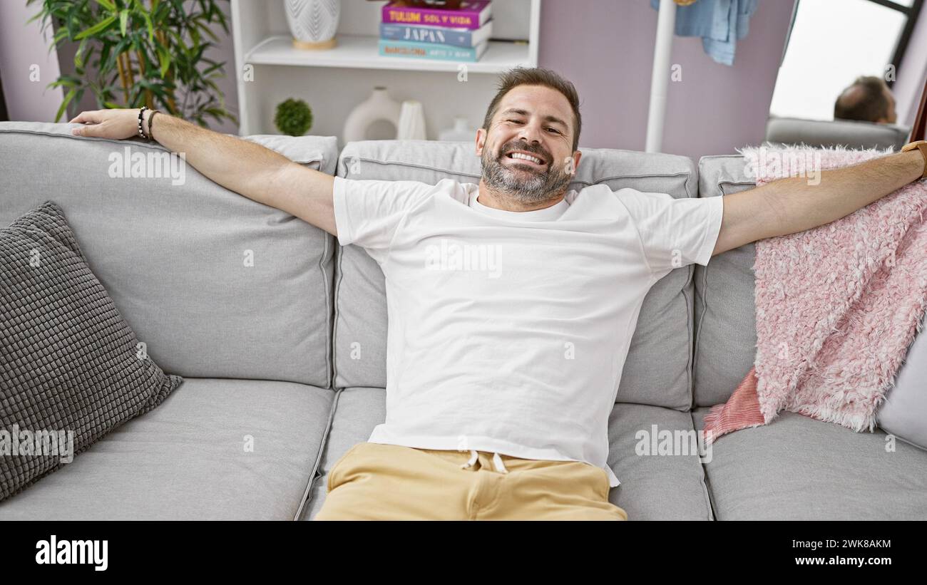 Relaxed man lounging on sofa hi-res stock photography and images - Alamy
