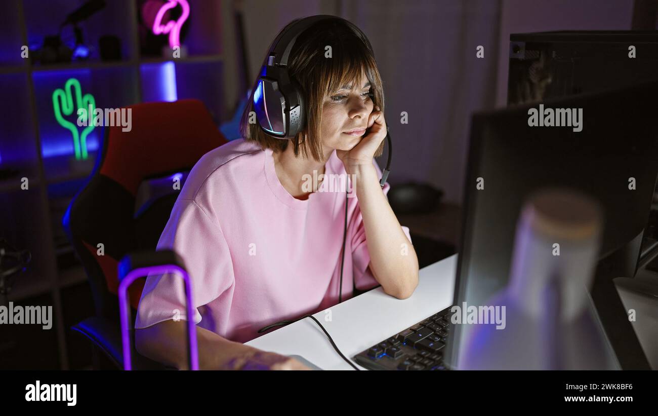 Young beautiful hispanic woman streamer boring playing video game using ...